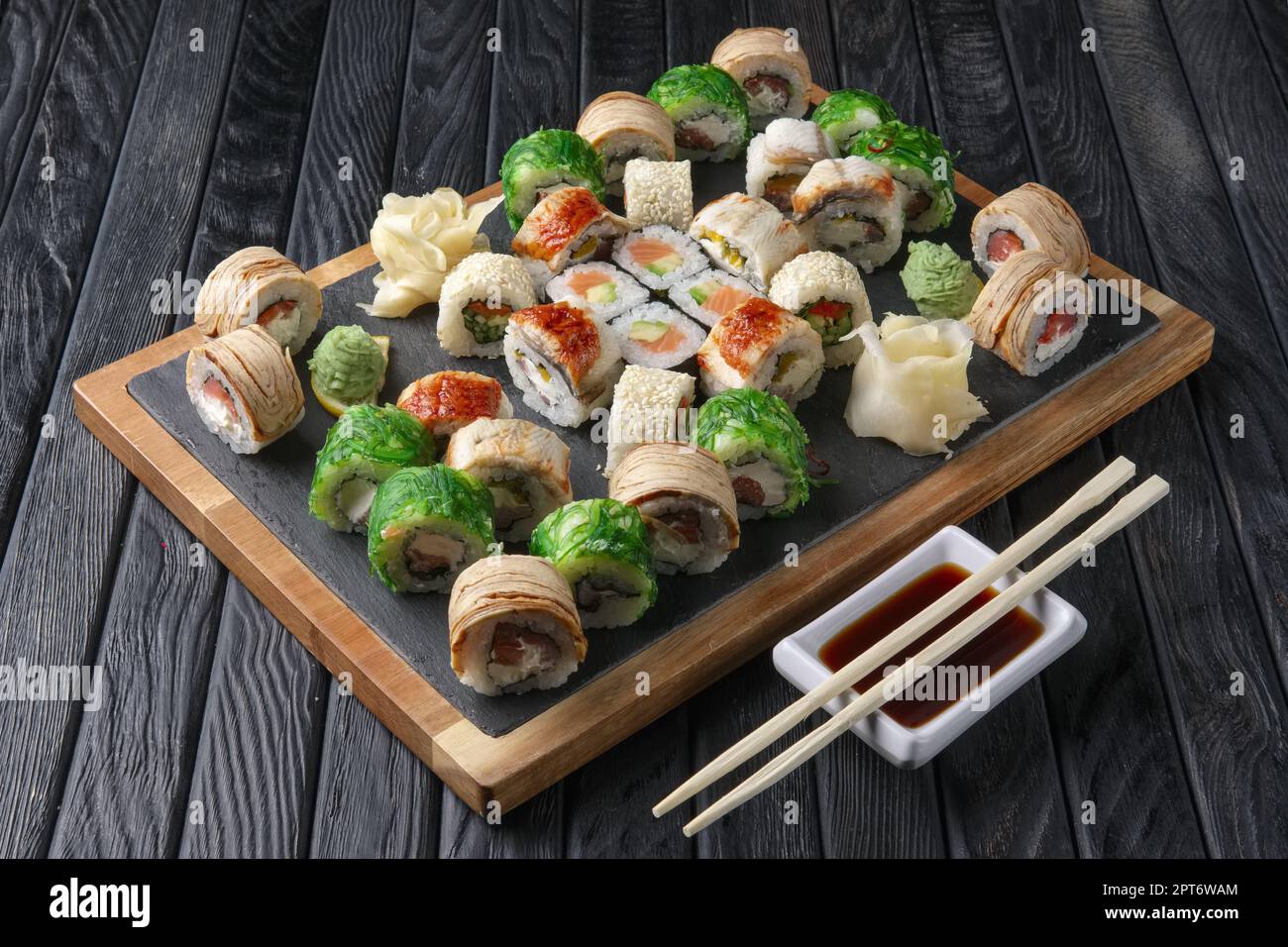 Big set of rolls served on stone plate. Layout for menu Stock Photo - Alamy