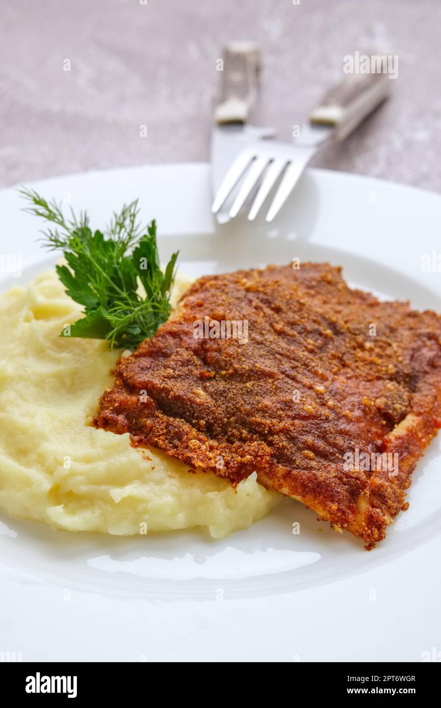 Fried hake fillet with spinach, cheese and rice Stock Photo - Alamy