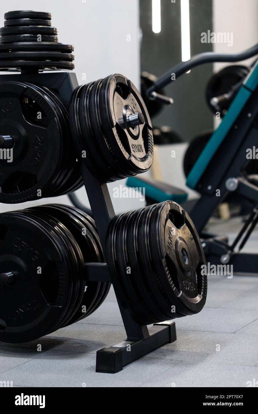 Modern disks for barbell in gym. Black metal weight plates for barbell ...