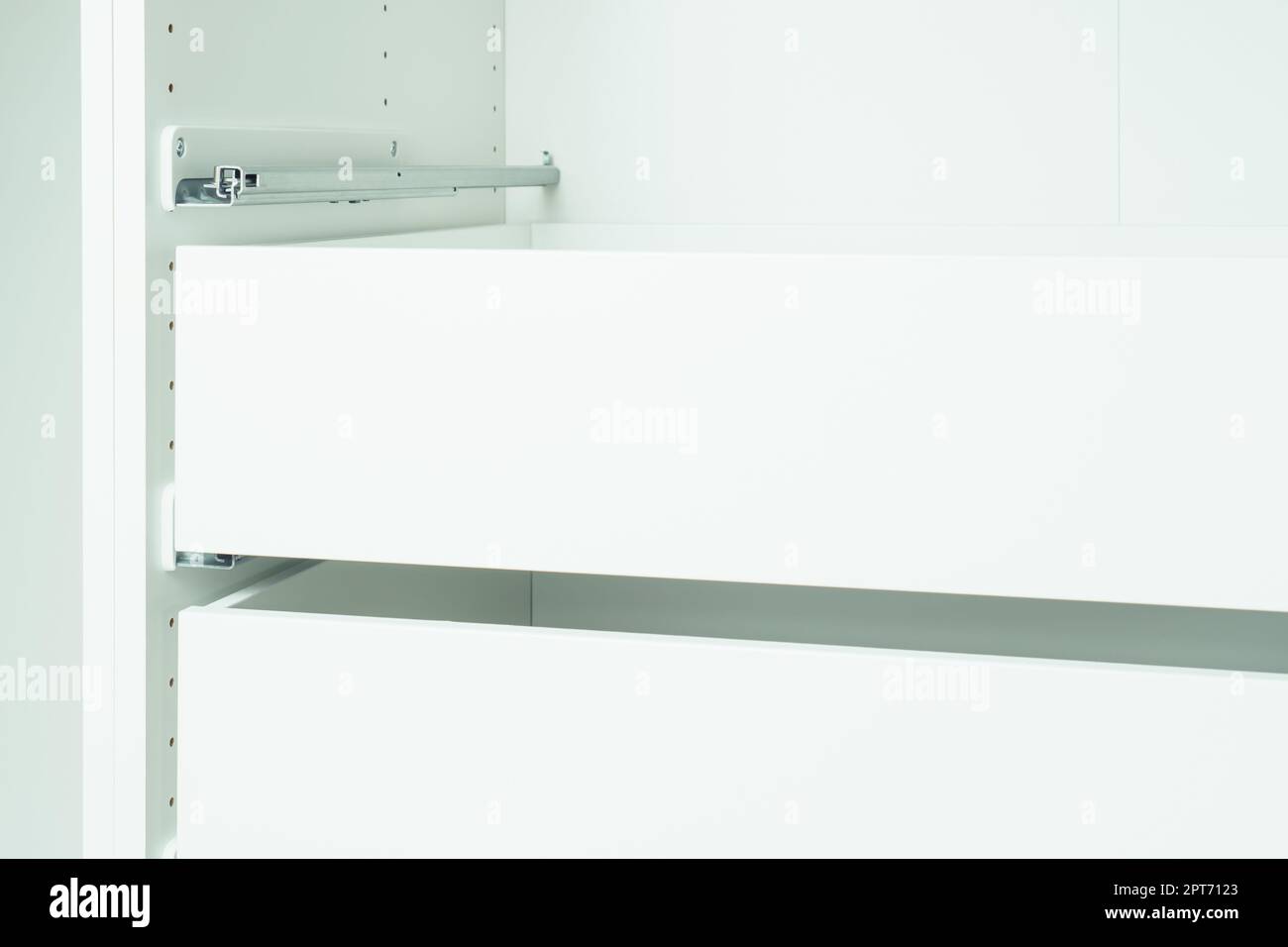 Drawer rail inserted into cabinet, fixed with self-tapping screws ...