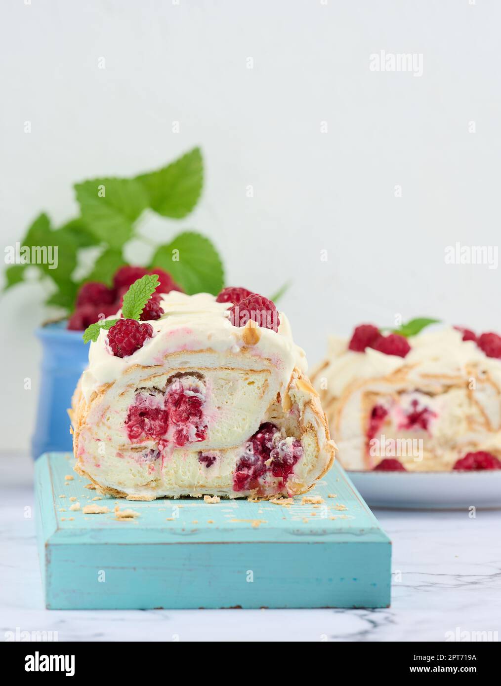 Baked meringue roll with cream and fresh red raspberry, white ...