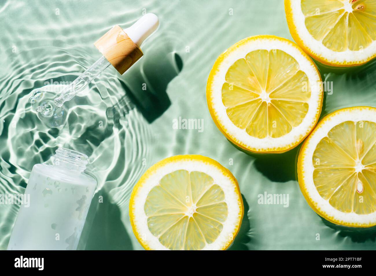 Facial pipette serum, whey beauty product near fruit citrus lemon in ...