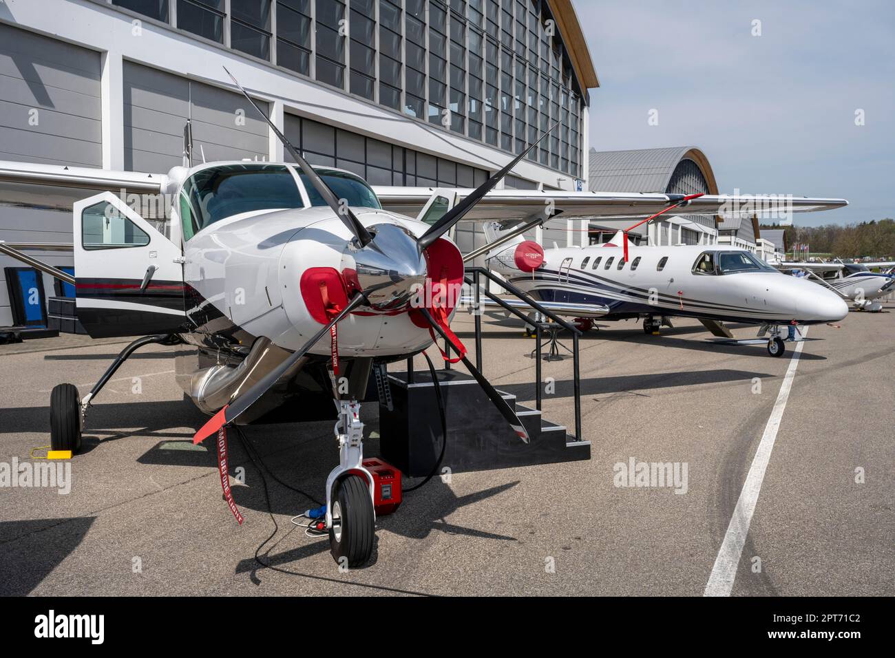Business jets are lined up in front of the exhibition halls during the ...