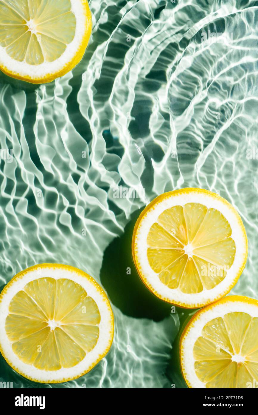 Transparent fresh exhilarant wave water with flecks background, lemon ...