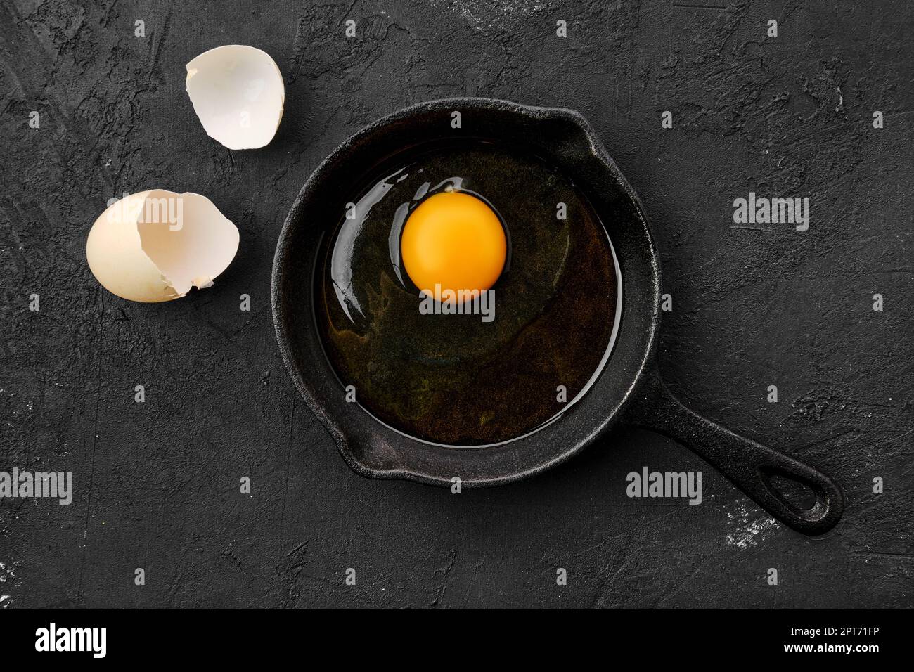 Raw uncooked egg in small cast iron skillet Stock Photo - Alamy