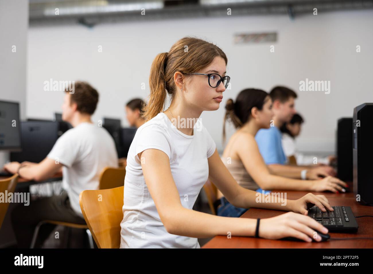 Teenager girl using PC during computer science lesson Stock Photo - Alamy