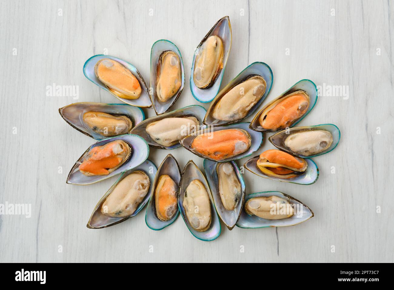 Raw large mussels in half shell on wooden background Stock Photo - Alamy