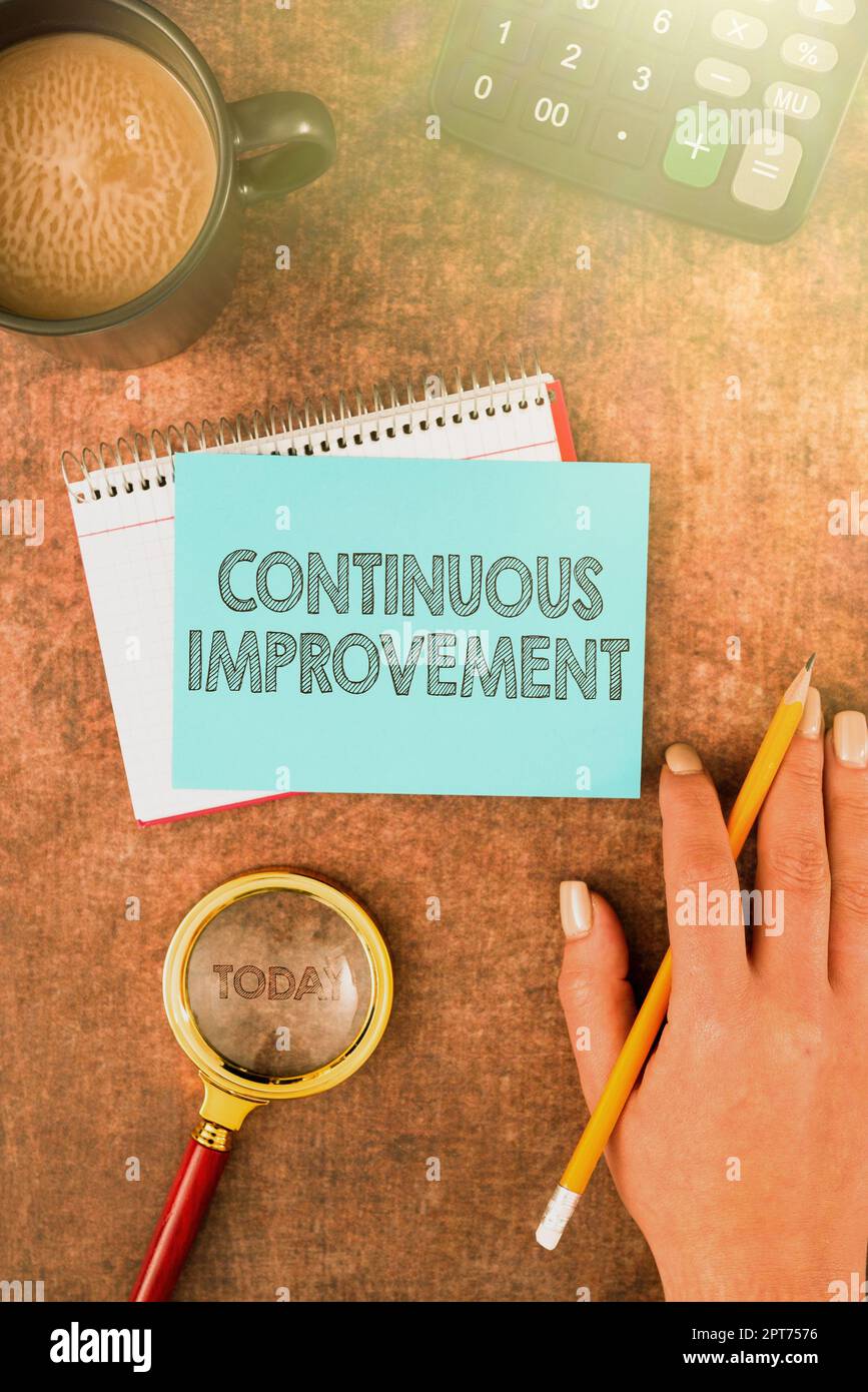 Hand writing sign Continuous Improvement, Business concept Ongoing ...