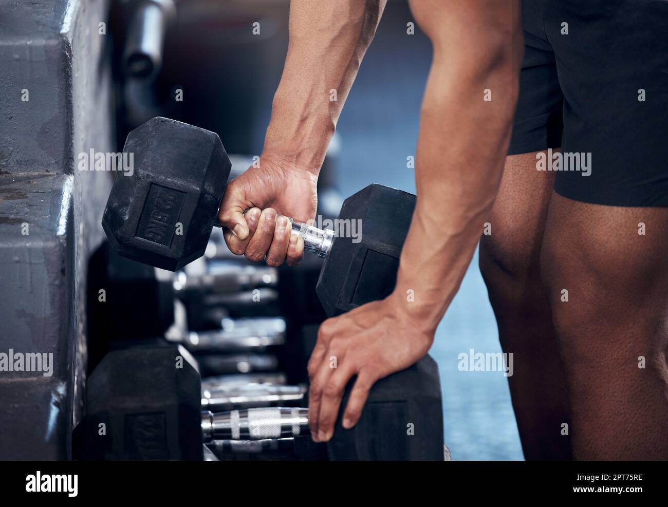 Closeup of man, workout and hands weightlifting with dumbbell in gym ...