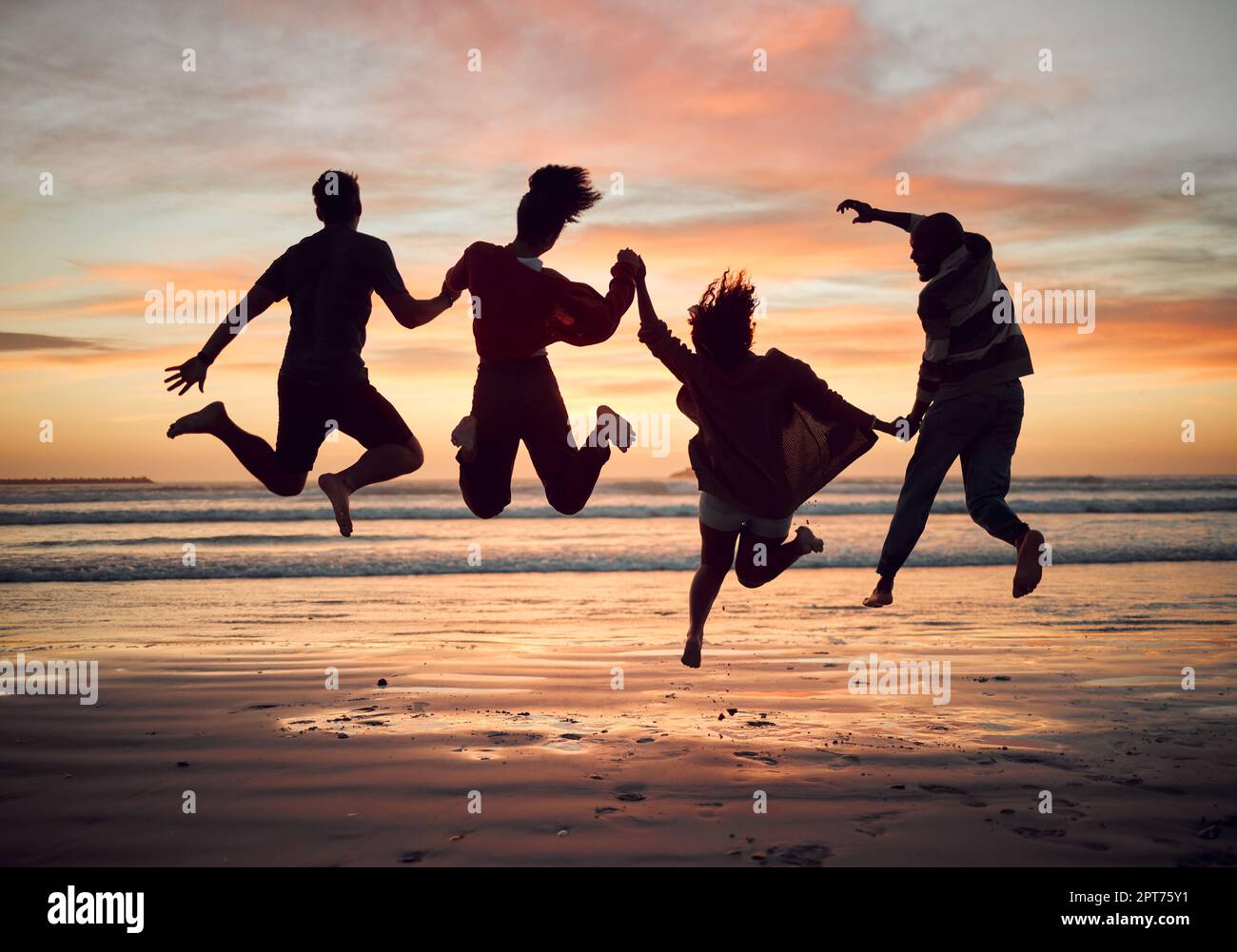 Friends Jumping On The Beach