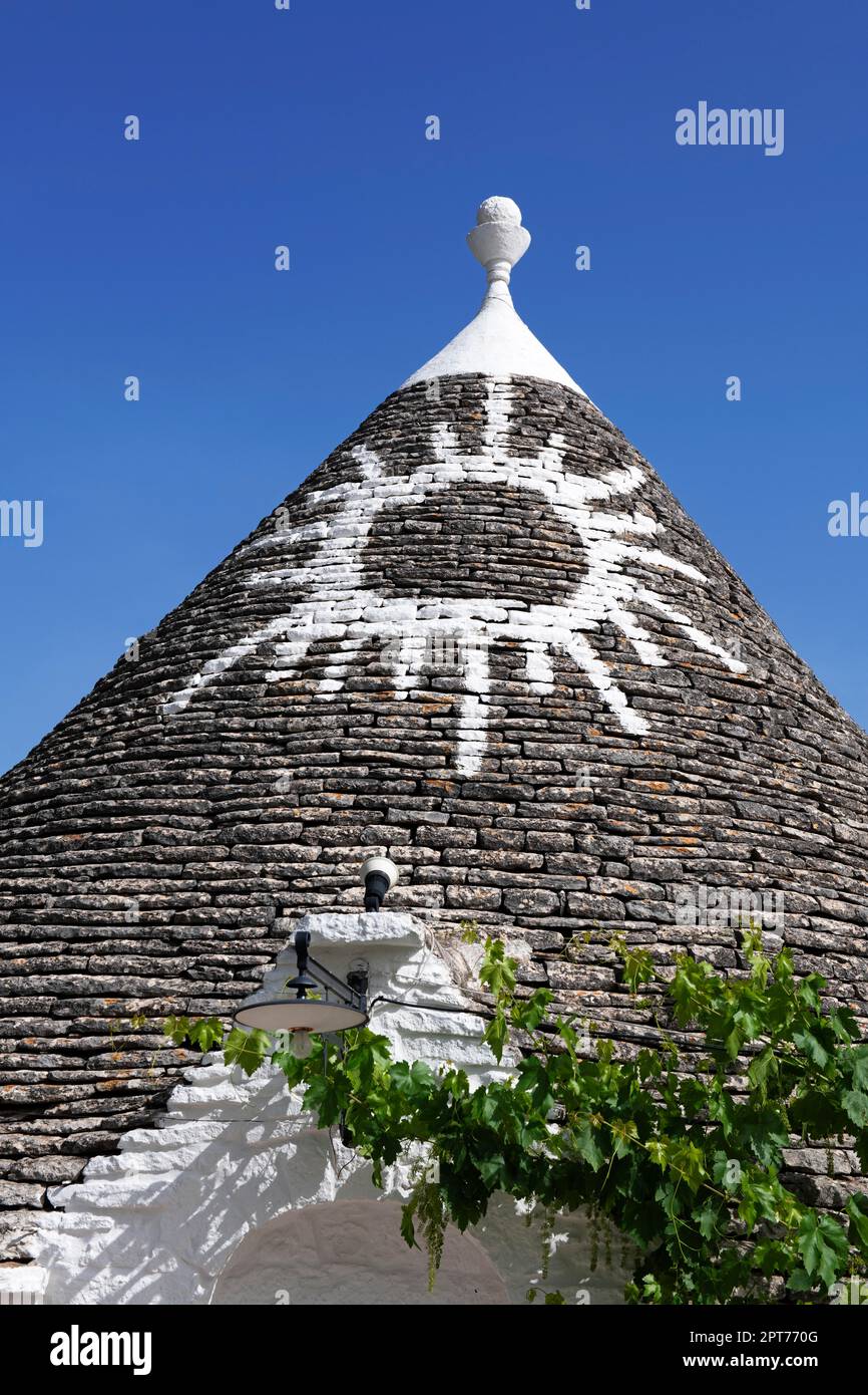 Trulli with symbol on the roof, sun, Alberobello, Valle d'Itria, Apulia ...