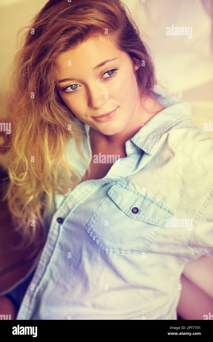 Reminiscing on her own. A pretty young girl relaxing indoors and ...