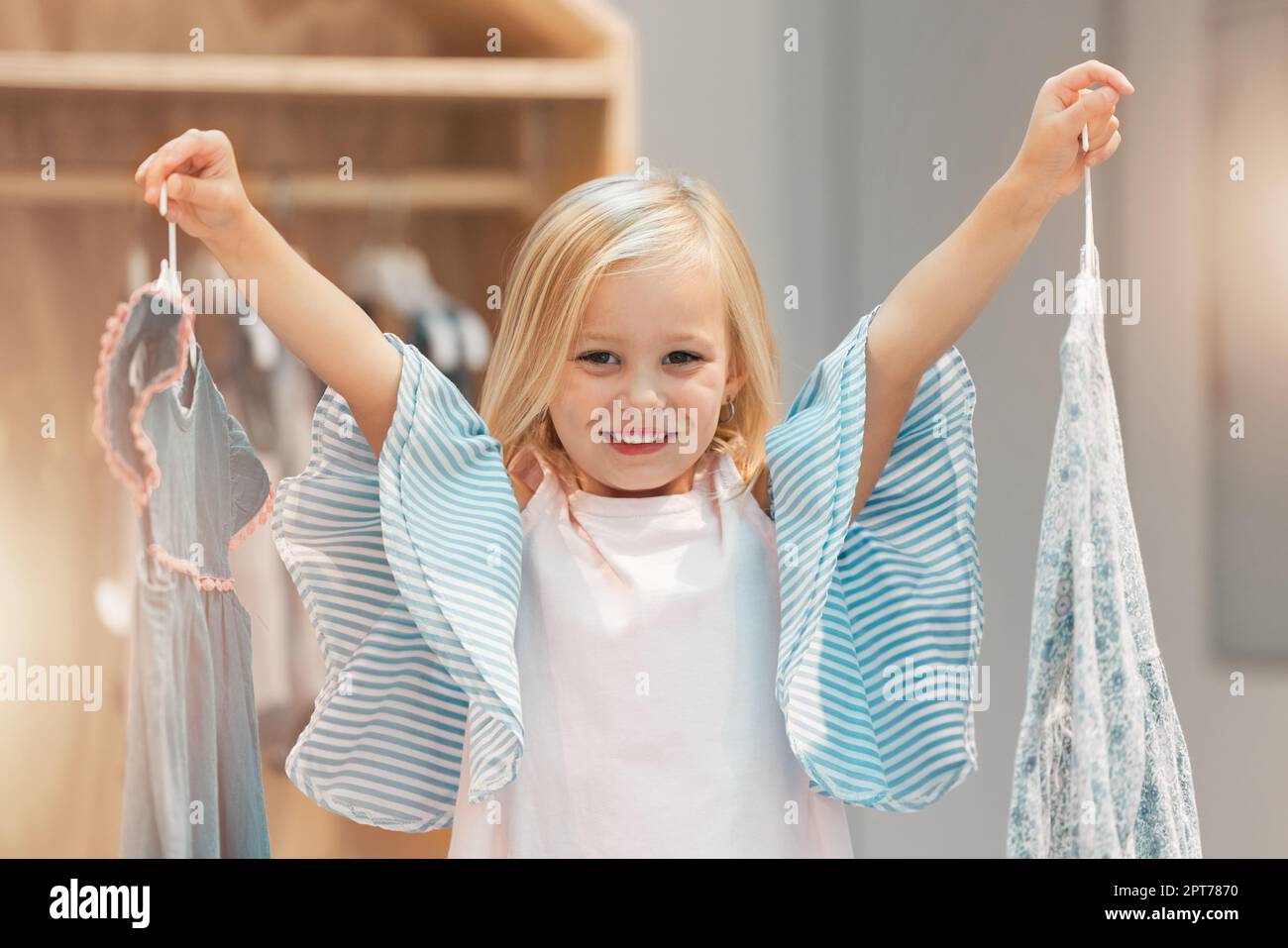 Girl child, choice or change clothes in fashion brand retail store ...
