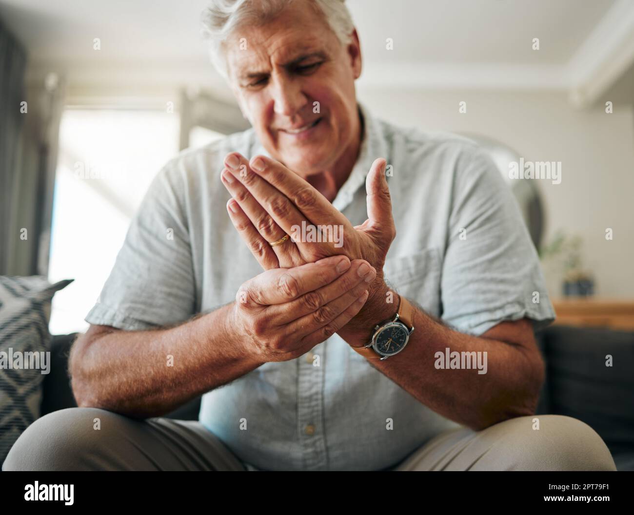 Hands, pain and arthritis with a senior man holding his hand while ...