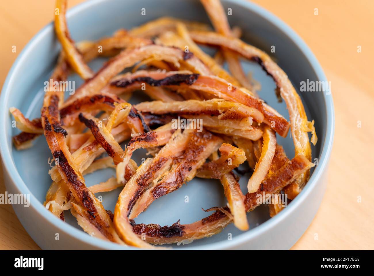 Dried squid snack in the plate Stock Photo - Alamy
