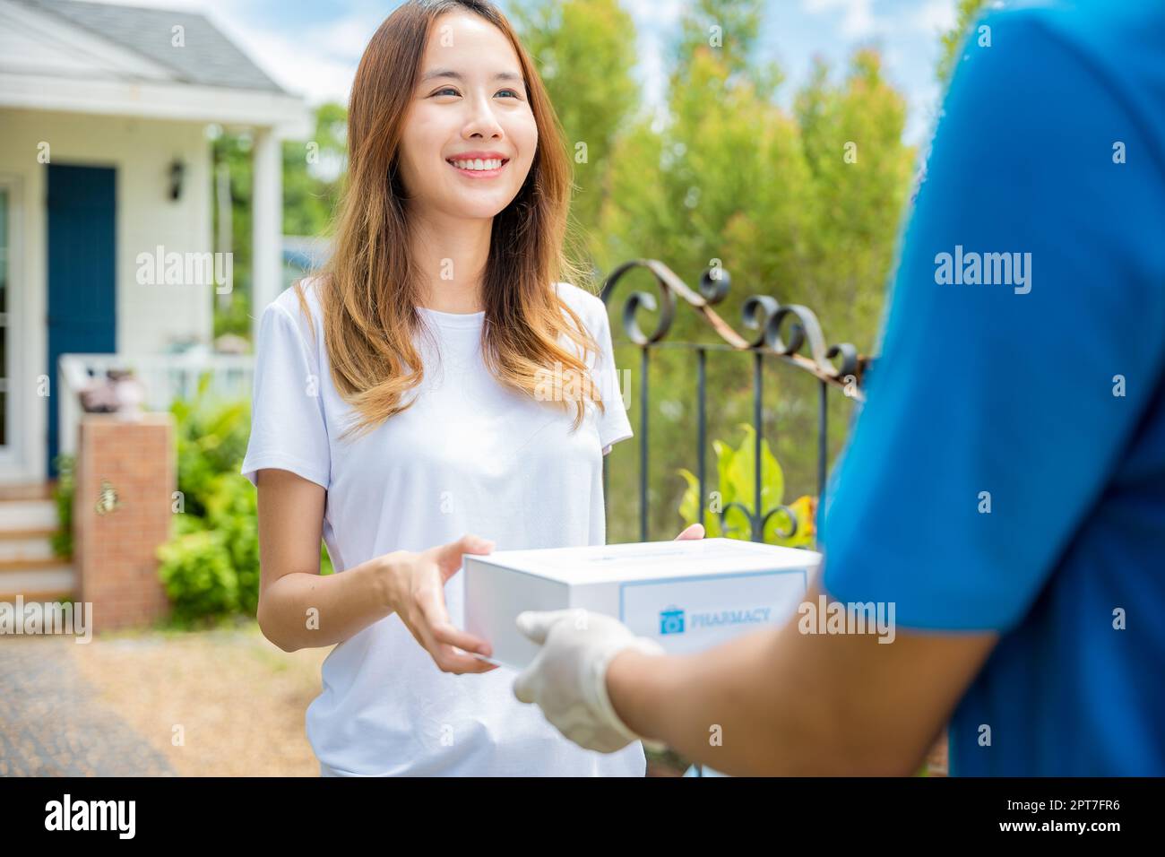 Sick Asian young woman receive medication first aid pharmacy box from ...