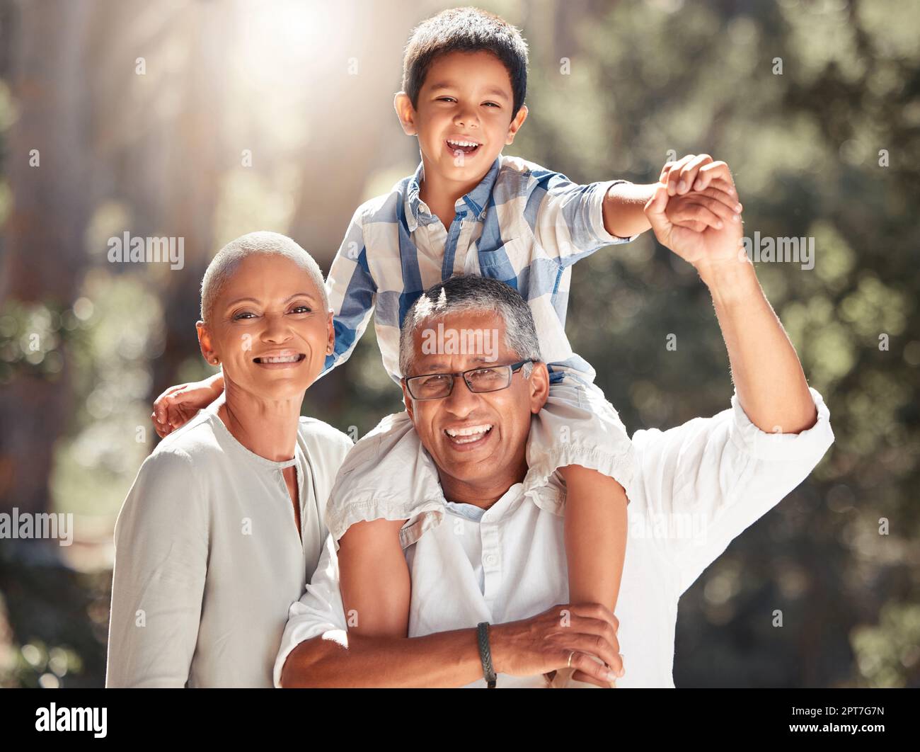 Happy family, portrait and grandparents with child in nature with a big ...