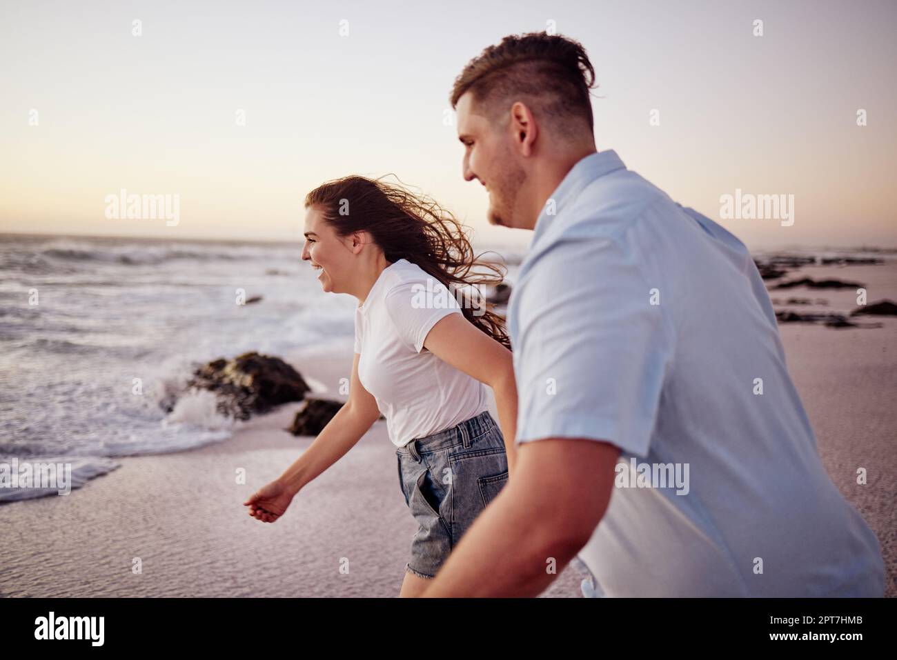 Love, beach and couple holding hands running to the water on a romantic ...