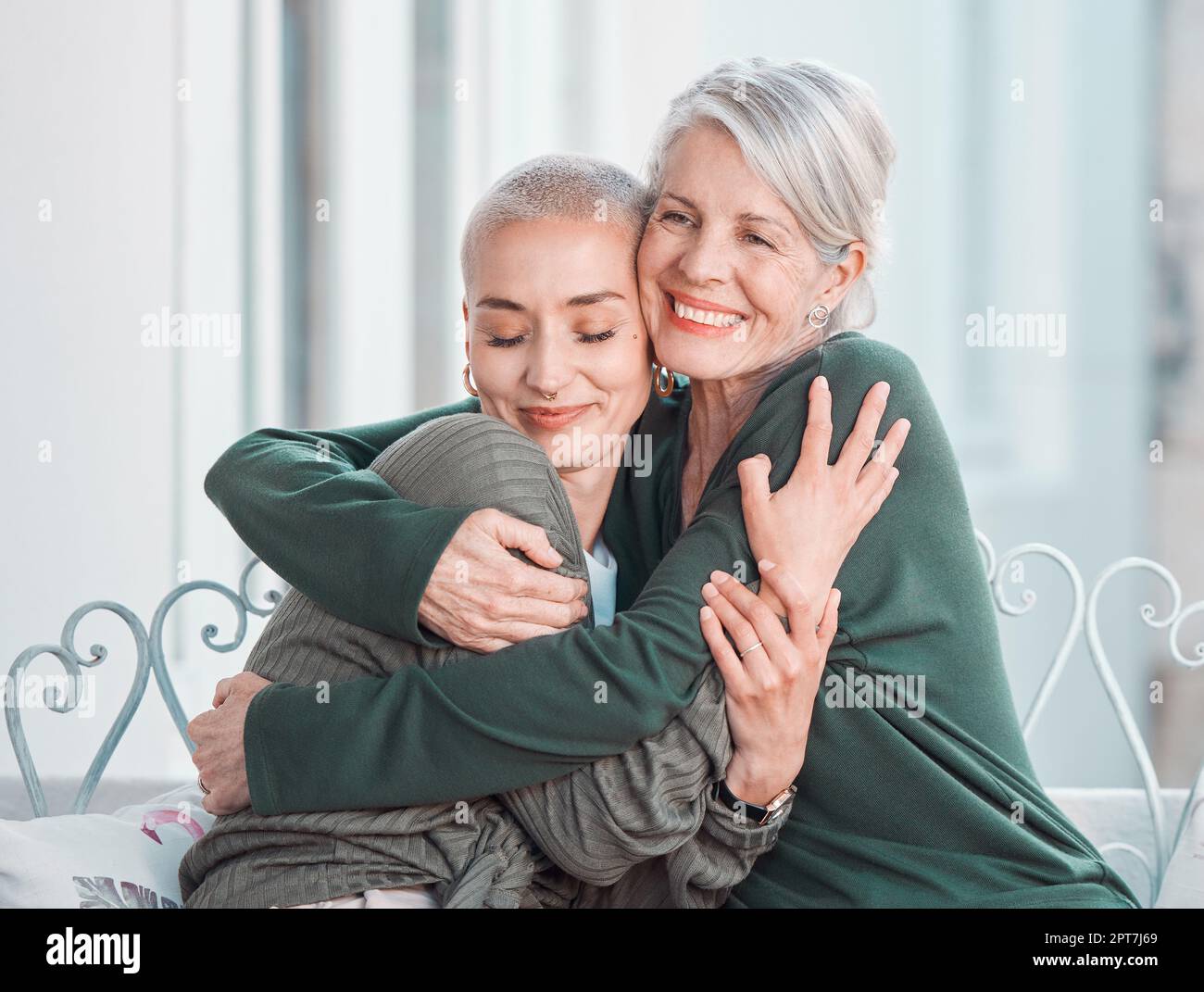 Cheerful senior mother hugging her adult daughter. Loving caucasian mom giving her daughter a ...