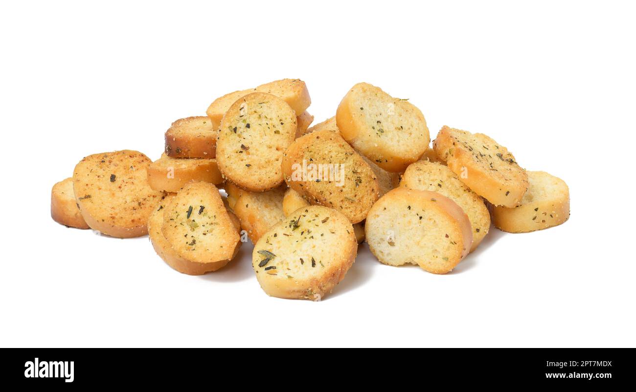 A pile of round bread croutons with spices on a white isolated ...