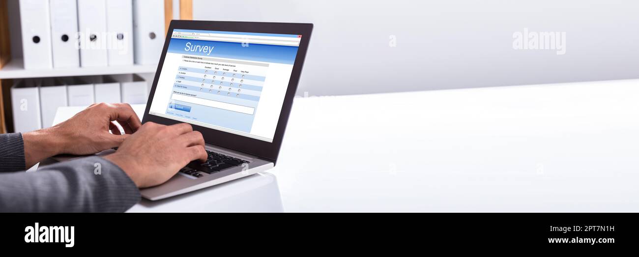 Man Filling Online Survey Form On Computer Stock Photo - Alamy