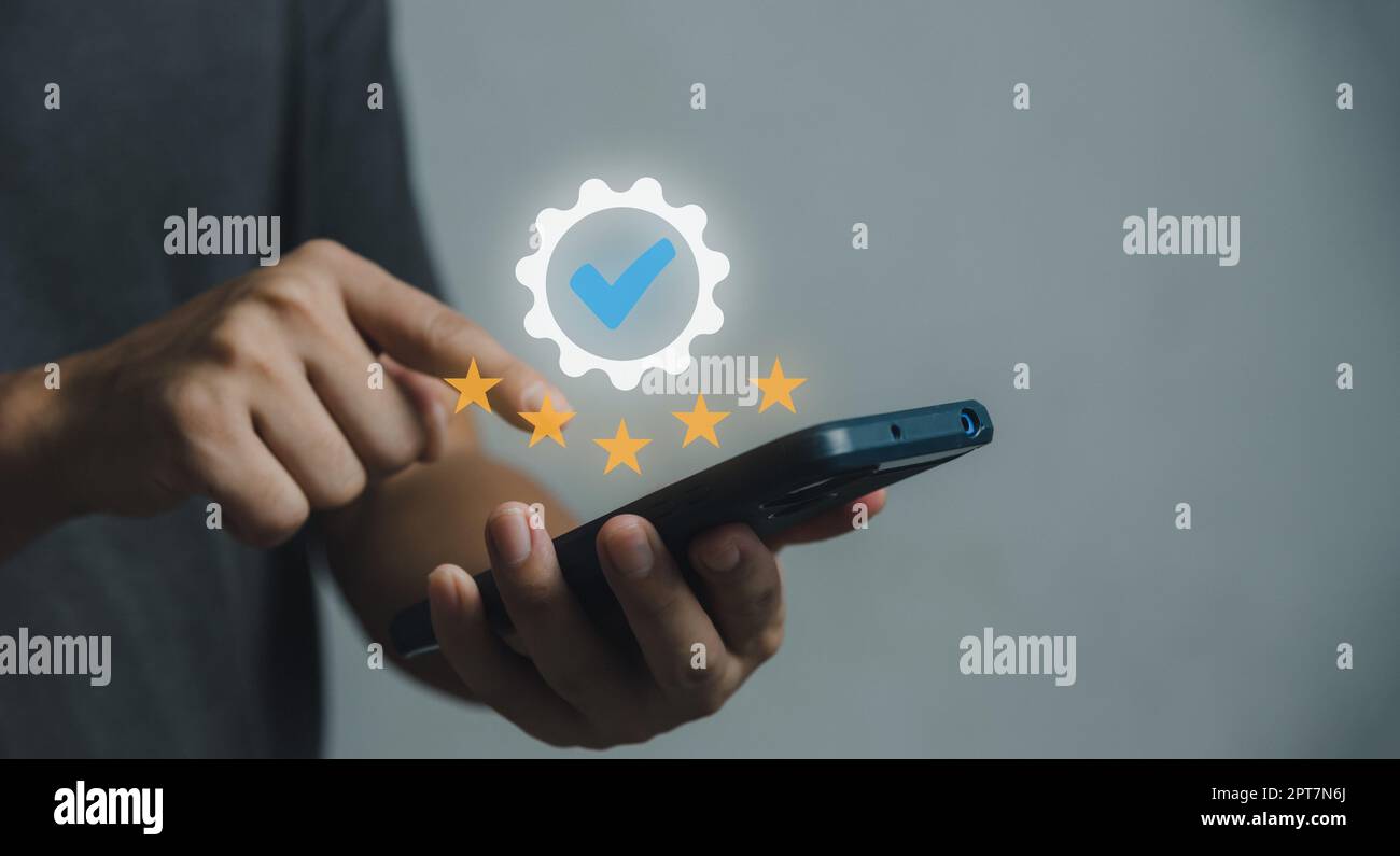Hand holding smartphone shows the sign service Quality assurance 5 star ...