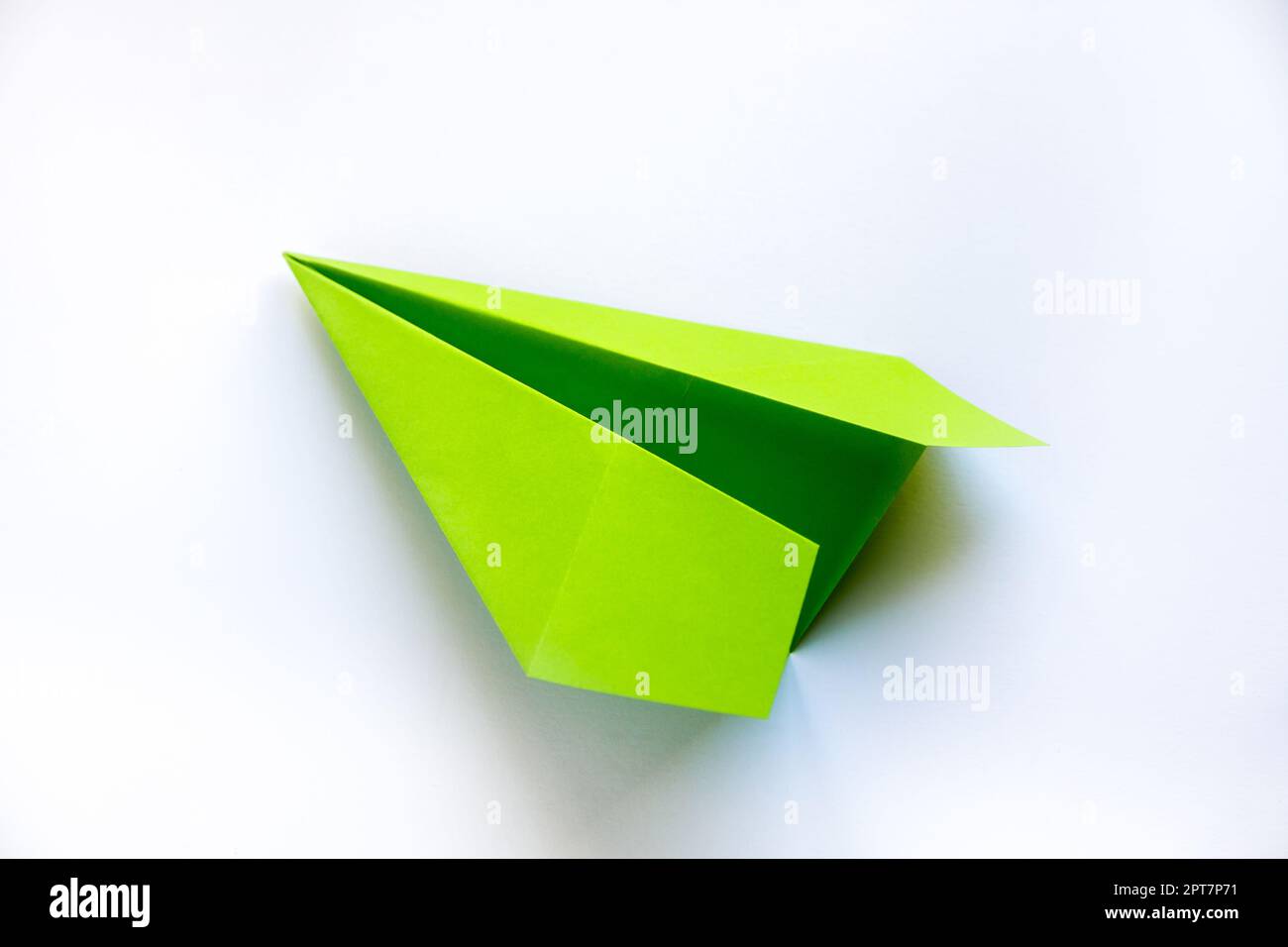 Green paper plane origami isolated on a blank white background Stock ...