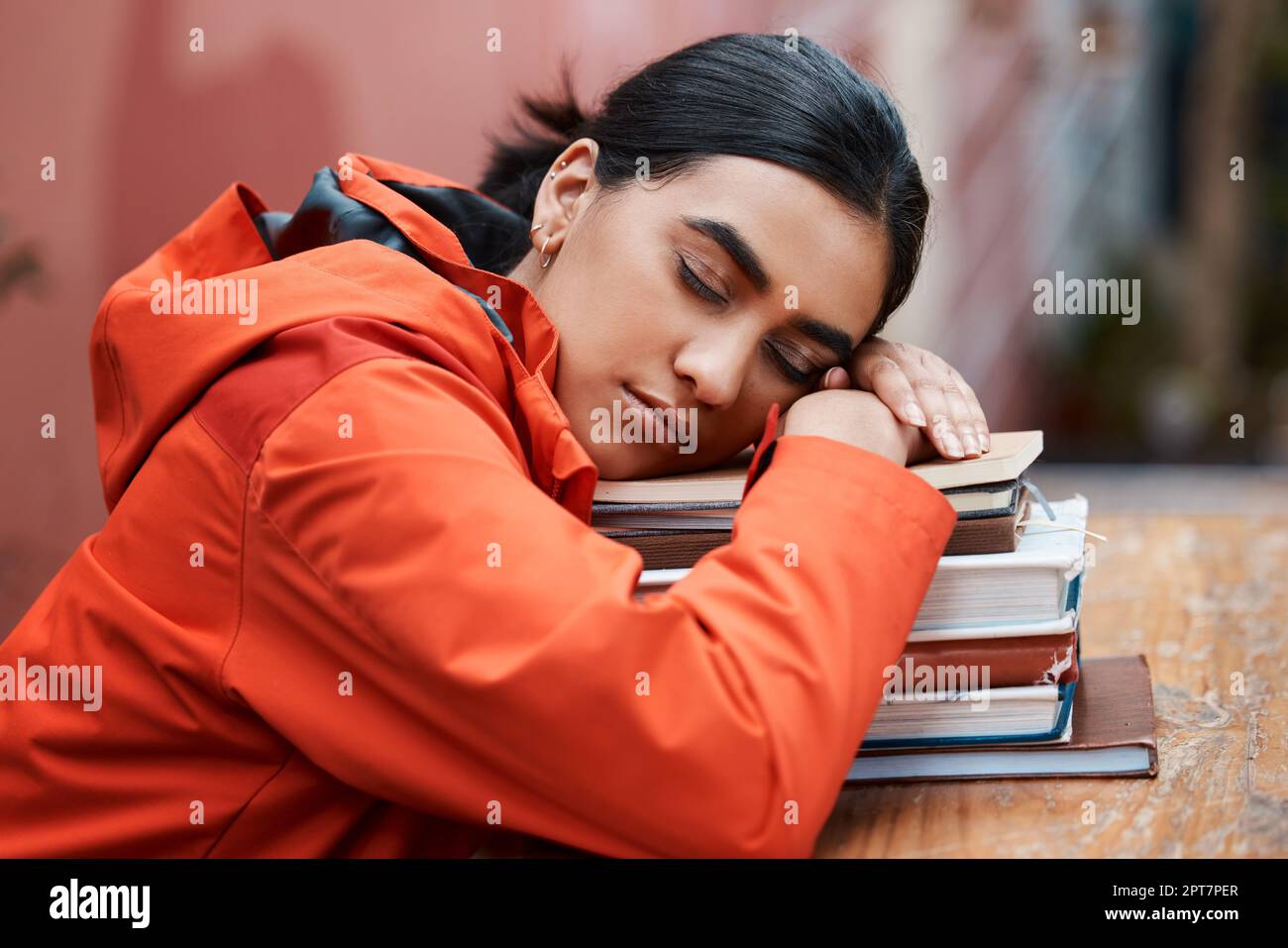 Ill just close my eyes for a bit. a young female student sleeping in a ...