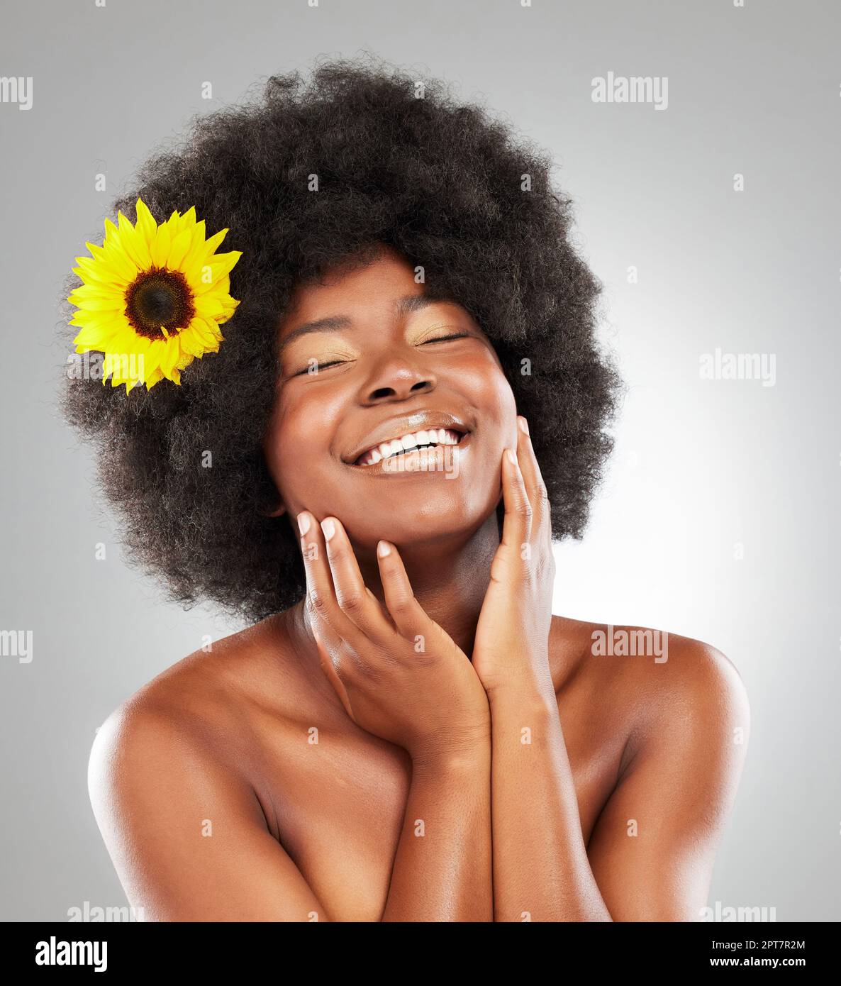 Carefree girls are happy girls. a young woman standing against a grey ...