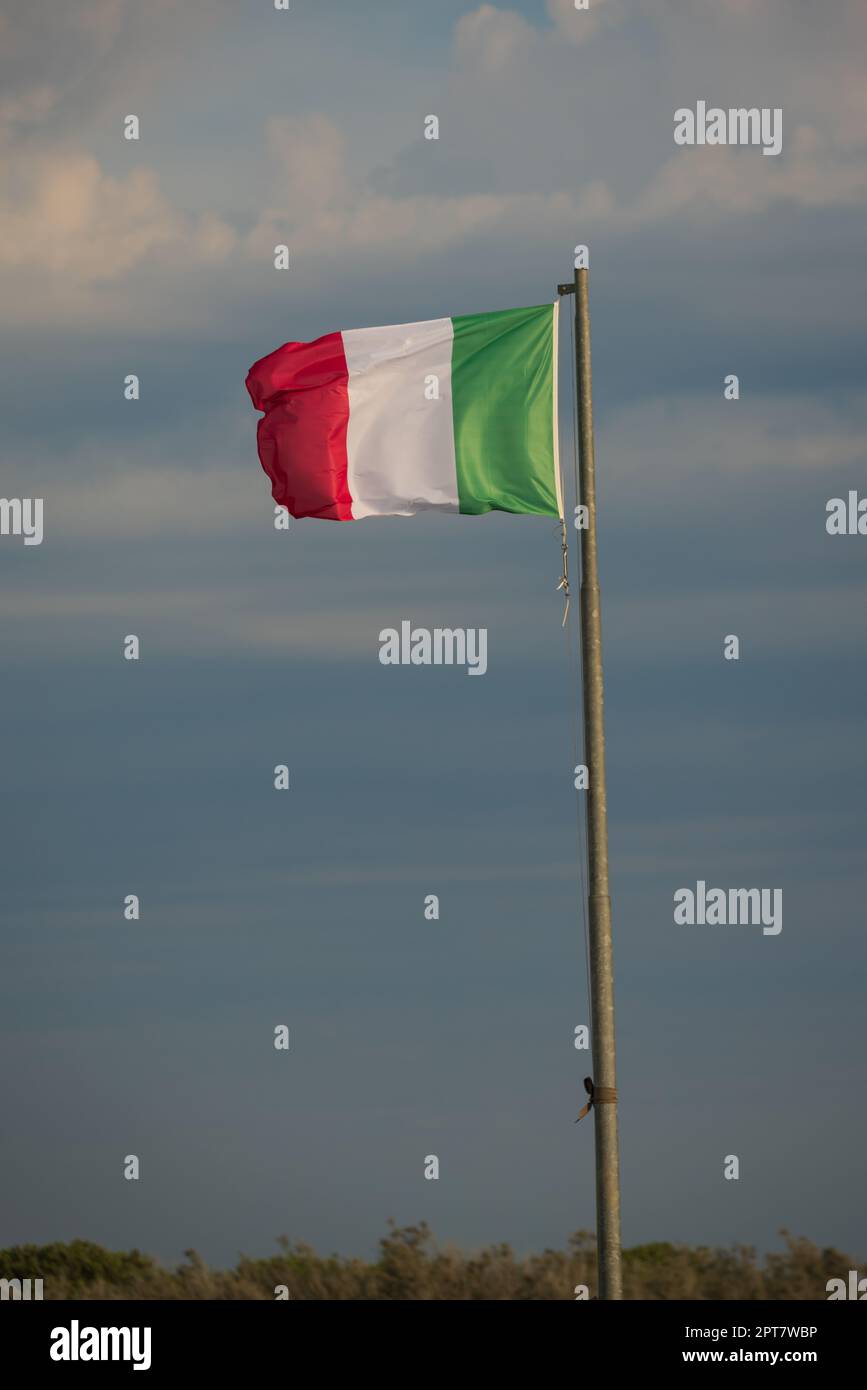 Large Italian flag waving in the wind at sunrise. Vertical photo Stock ...