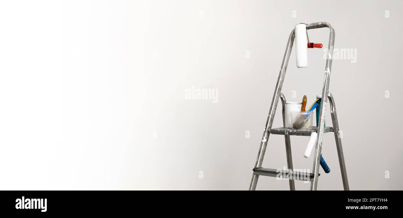 Ladder with paint buckets brushes and rollers for remodeling home ...