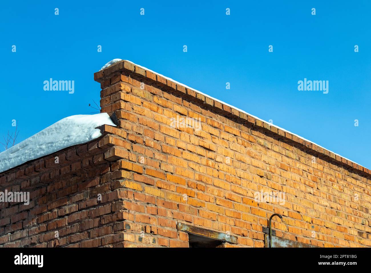 Brick brown old wall covered with snow Stock Photo - Alamy