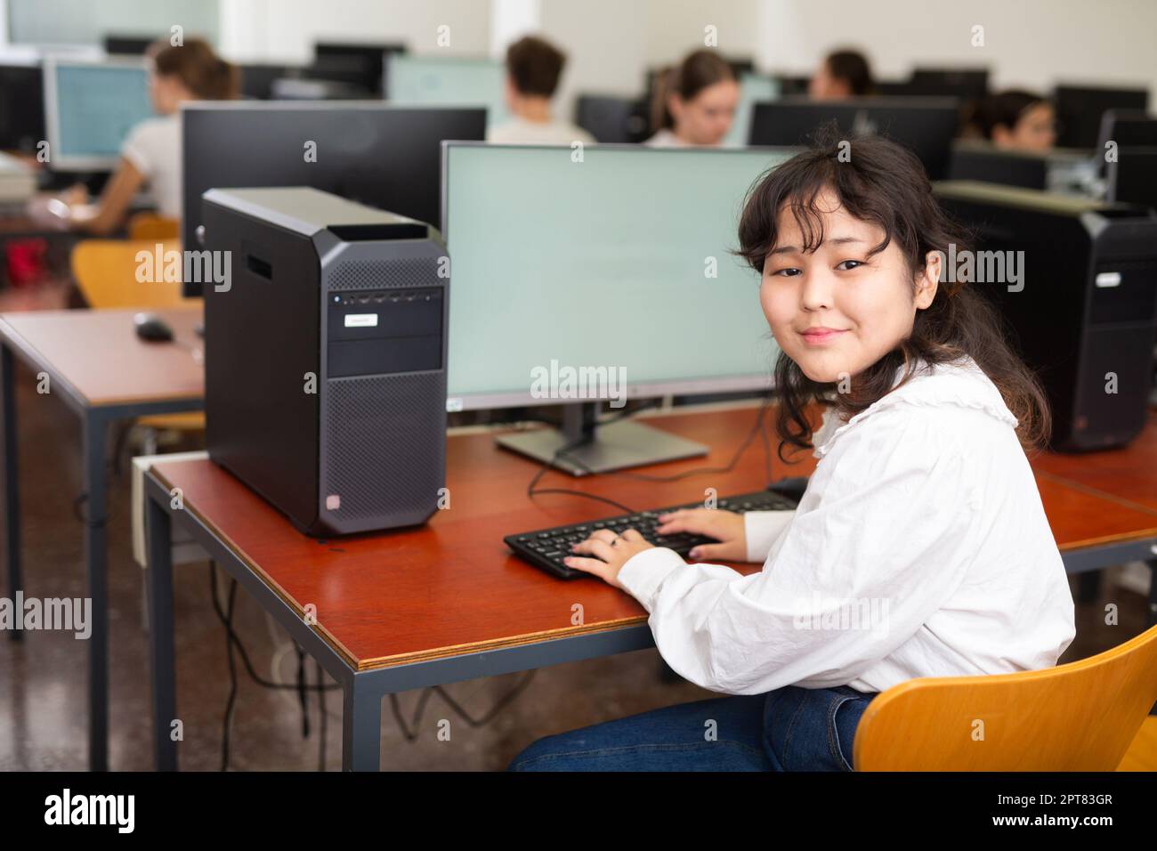 Smart Asian female teenager learning computer science while she is ...