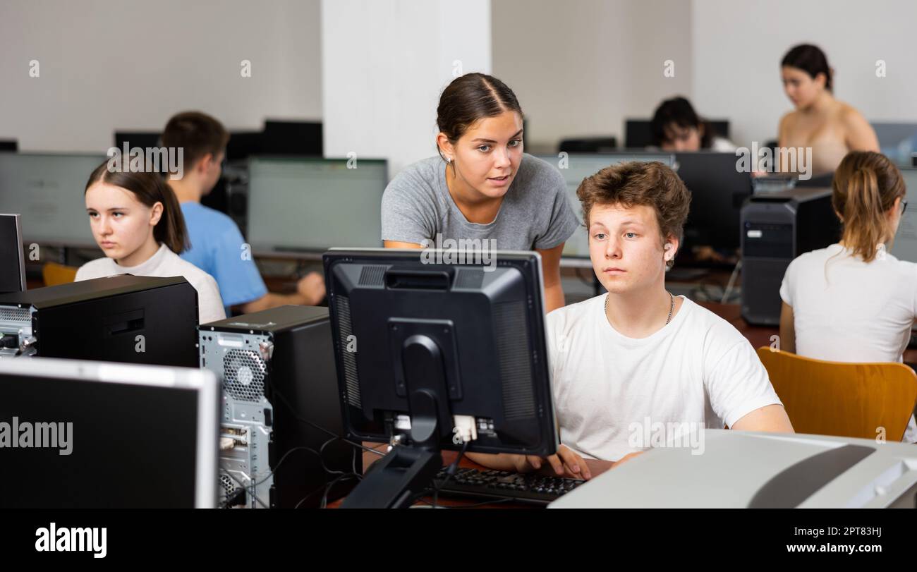 Teacher and teenage boy studying computer science Stock Photo - Alamy