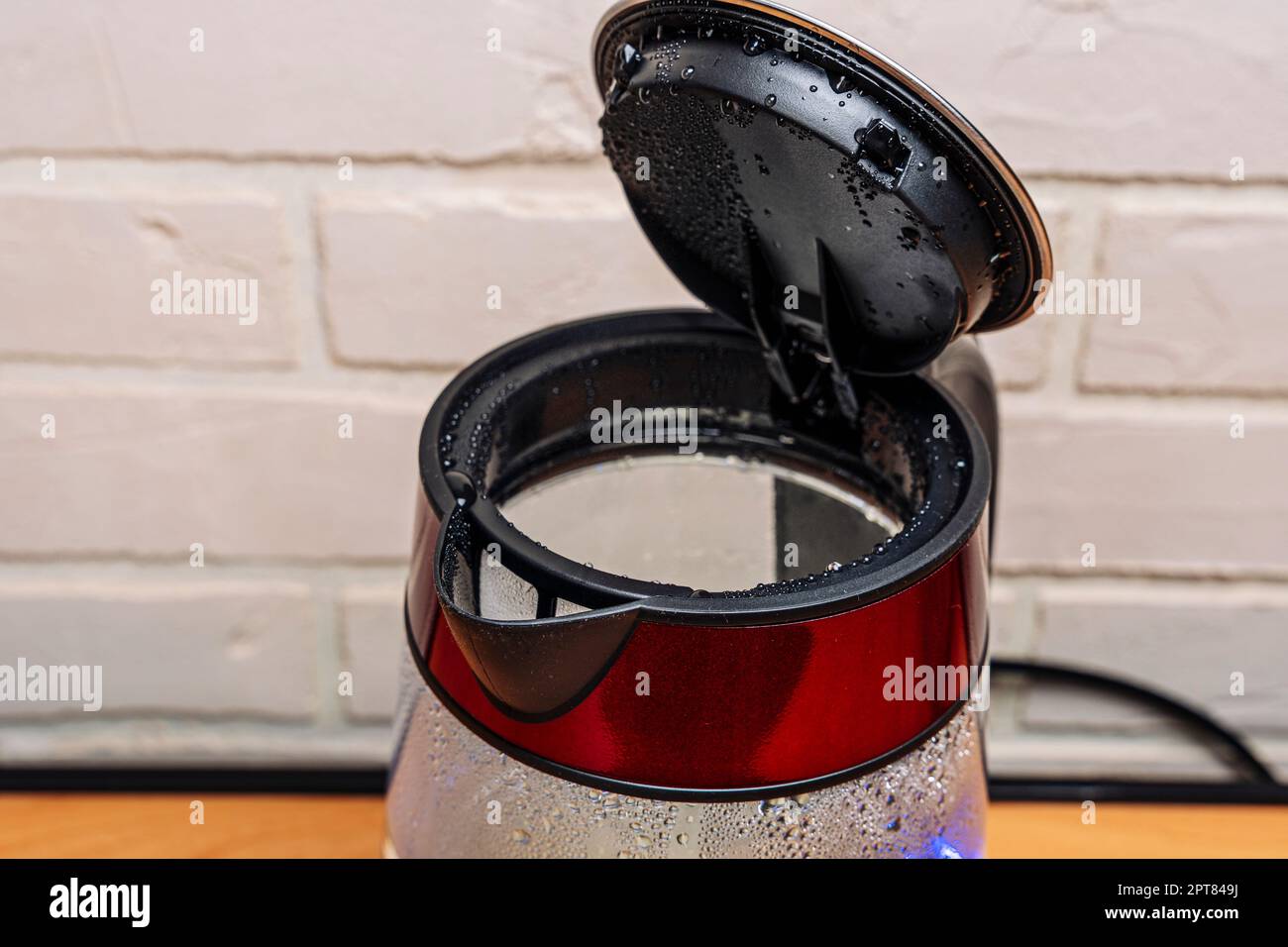 new modern boiling glass electric kettle close-up with bubbling water ...