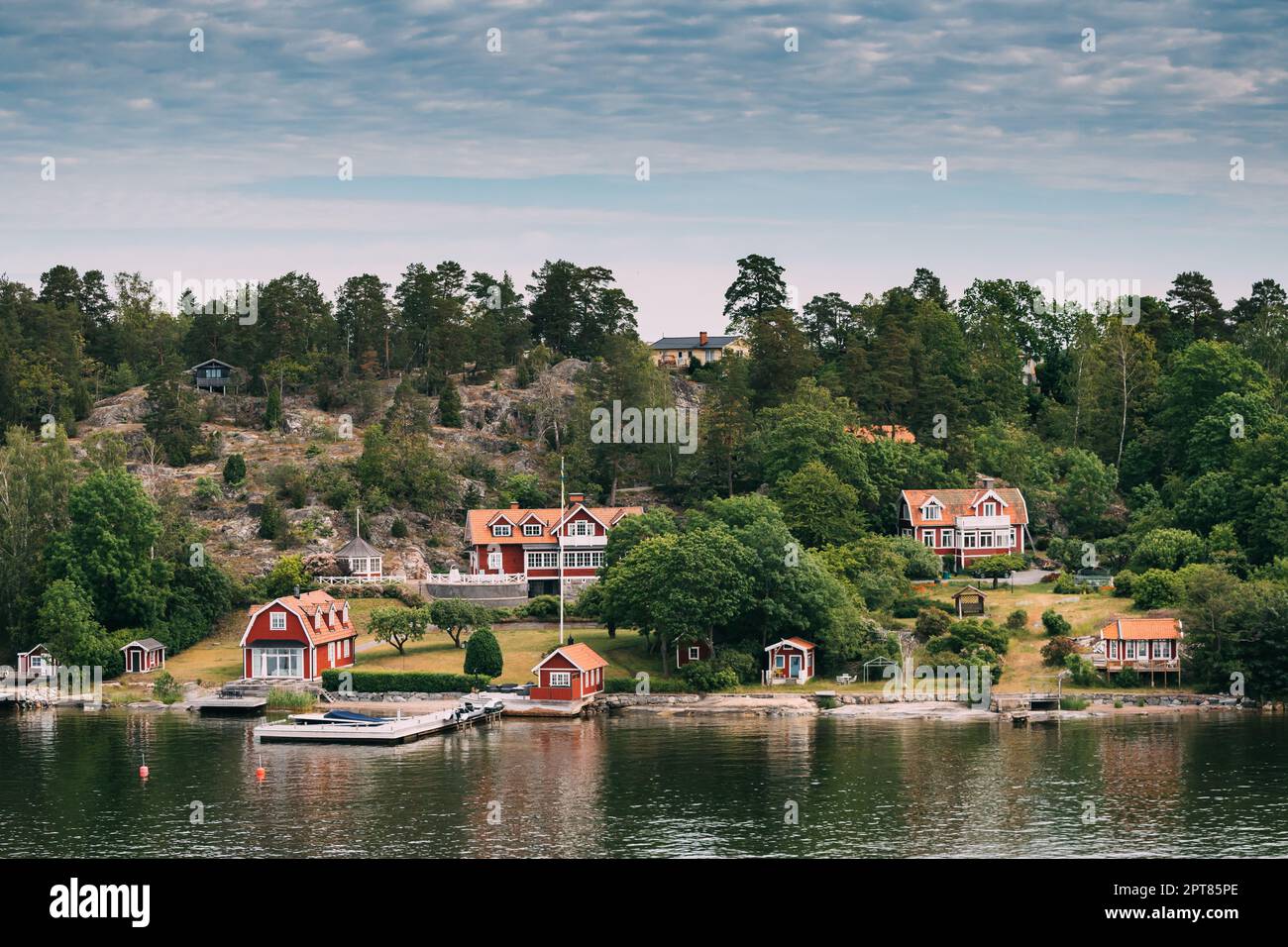 Sweden. Many Beautiful Red Swedish Wooden Log Cabins Houses On Rocky ...