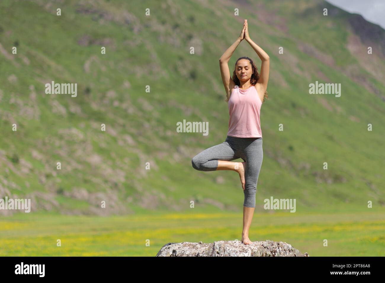 Front view portrait of a yogi doing yoga on a rock in nature Stock ...
