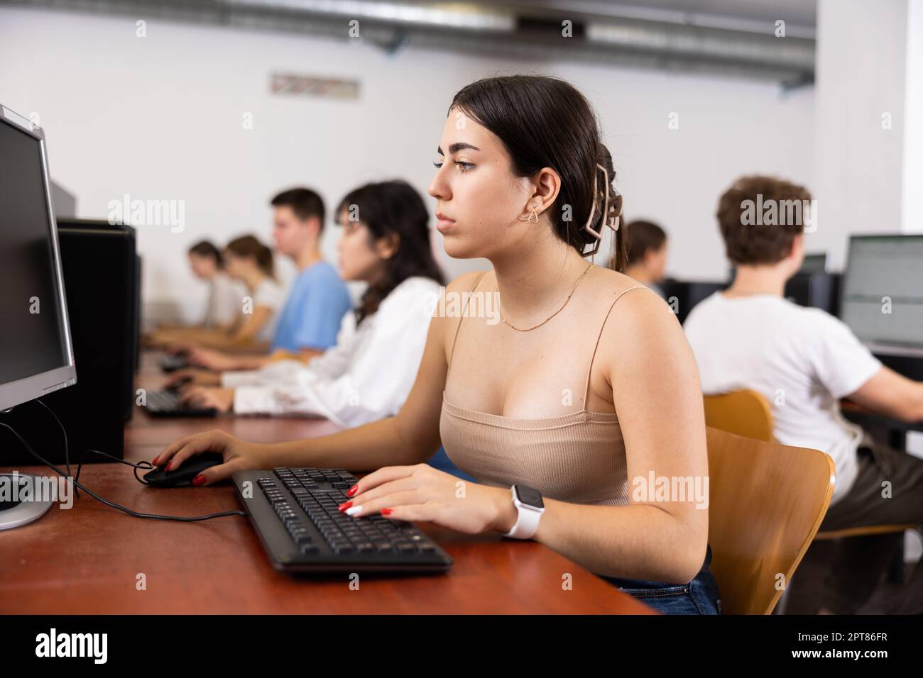 Side view on diligent college girl studying using pc in computer class Stock Photo - Alamy