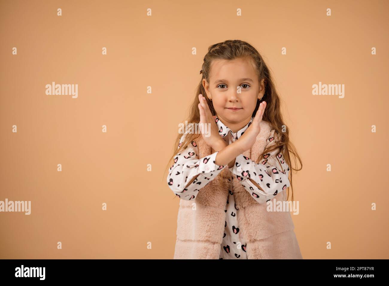 Cute little child girl making stop gesture on beige background Stock ...