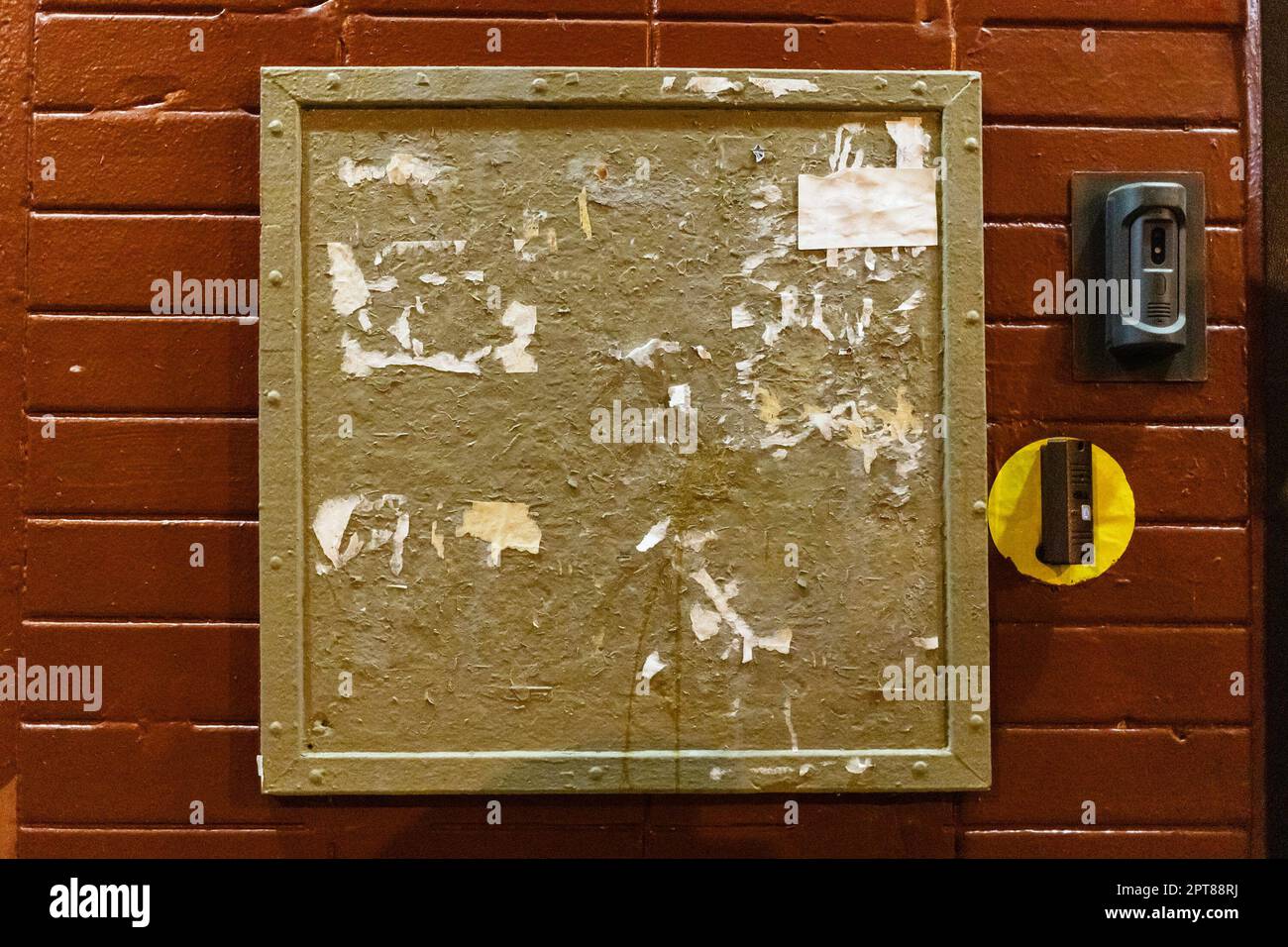 bulletin board at entrance of city residential building illuminated by ...