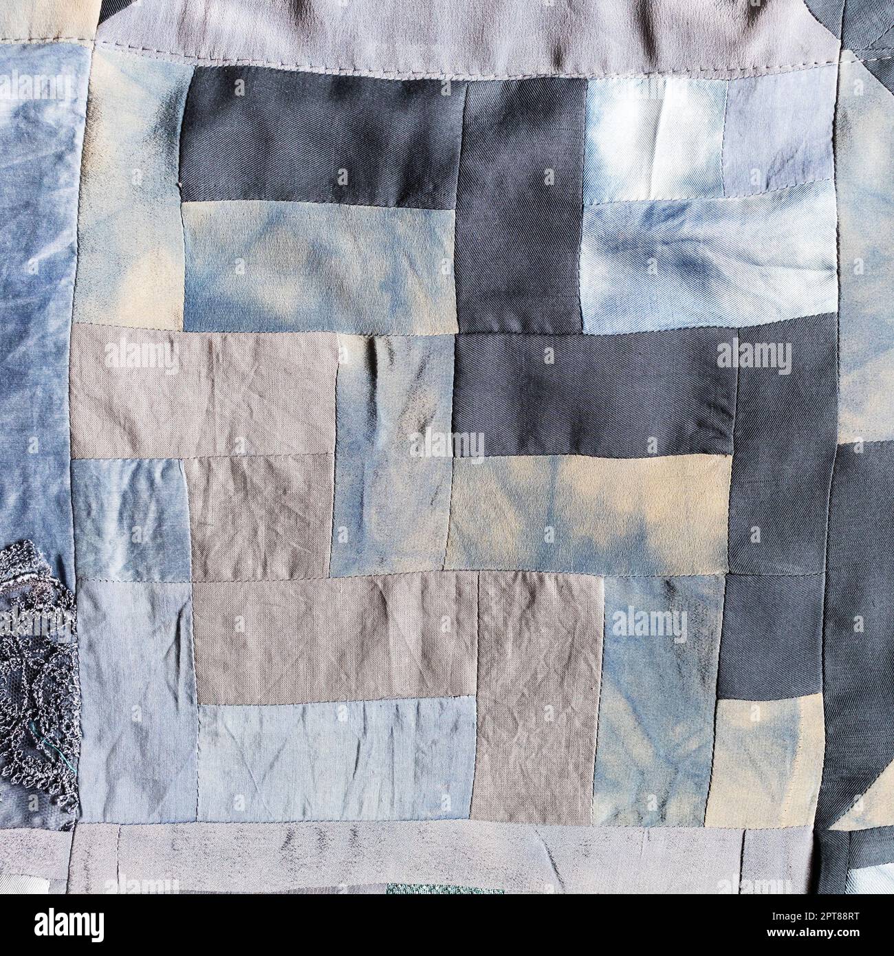 detail of hand-crafted patchwork quilt from pieces of various silk ...