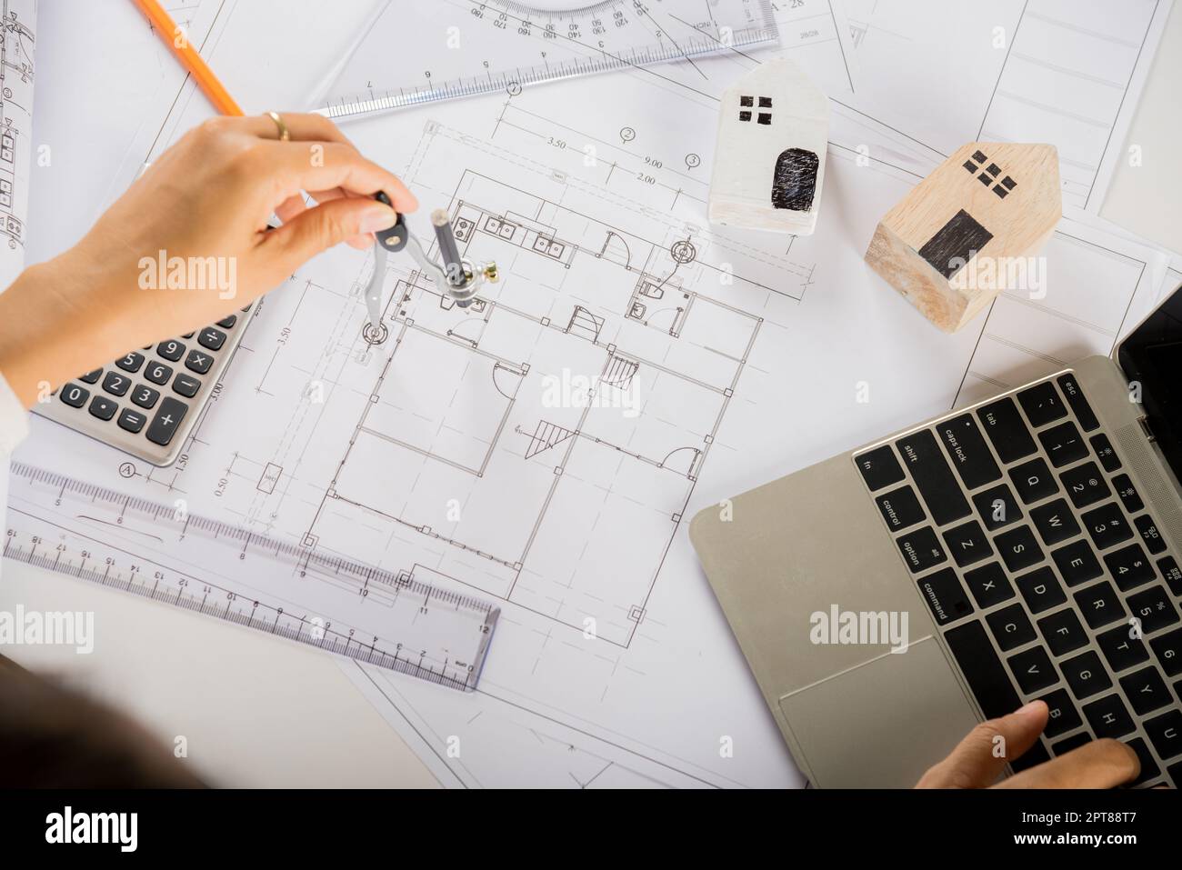 Architectural project workplace. Architect typing laptop keyboard to ...