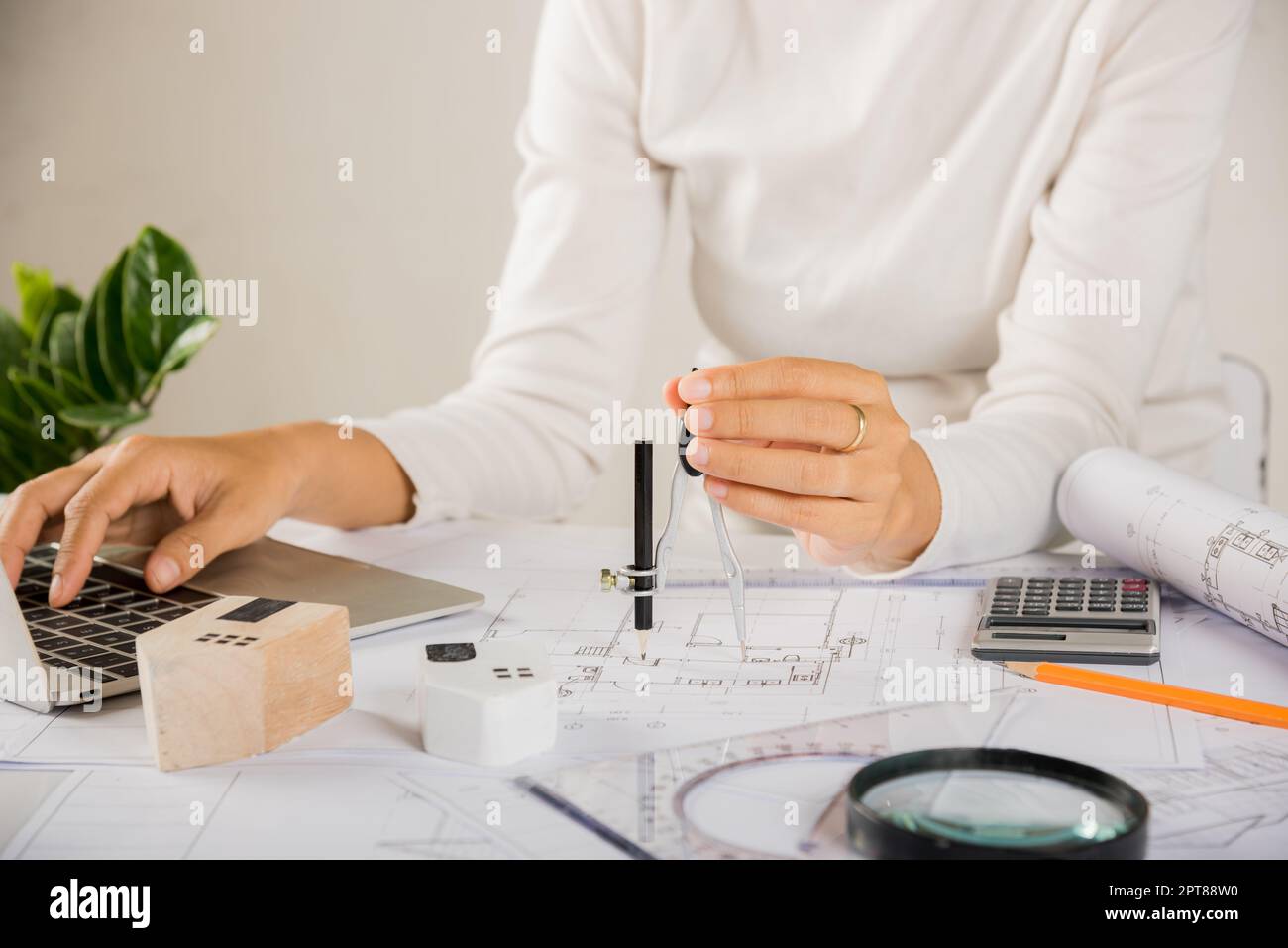 Architectural project workplace. Architect typing laptop keyboard to ...