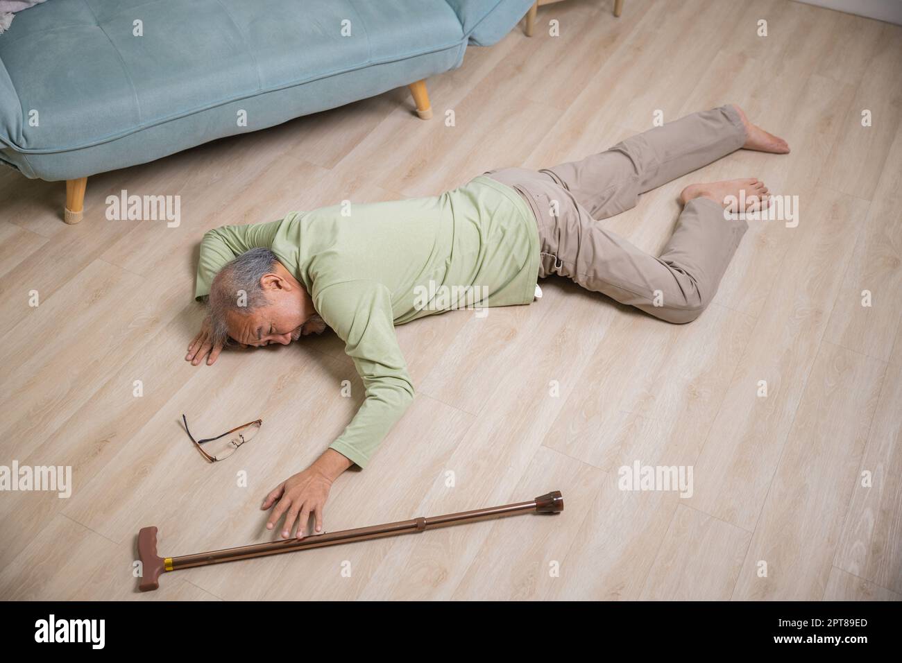 Sick senior old man falling down lying on floor because stumbled at ...