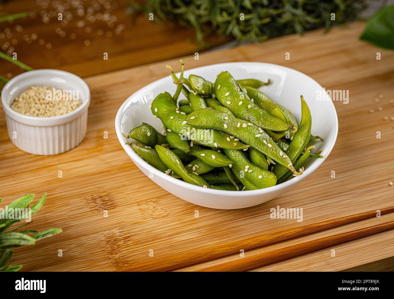 Fresh soya beans immature soybeans in the pod on a bowl with sesame ...