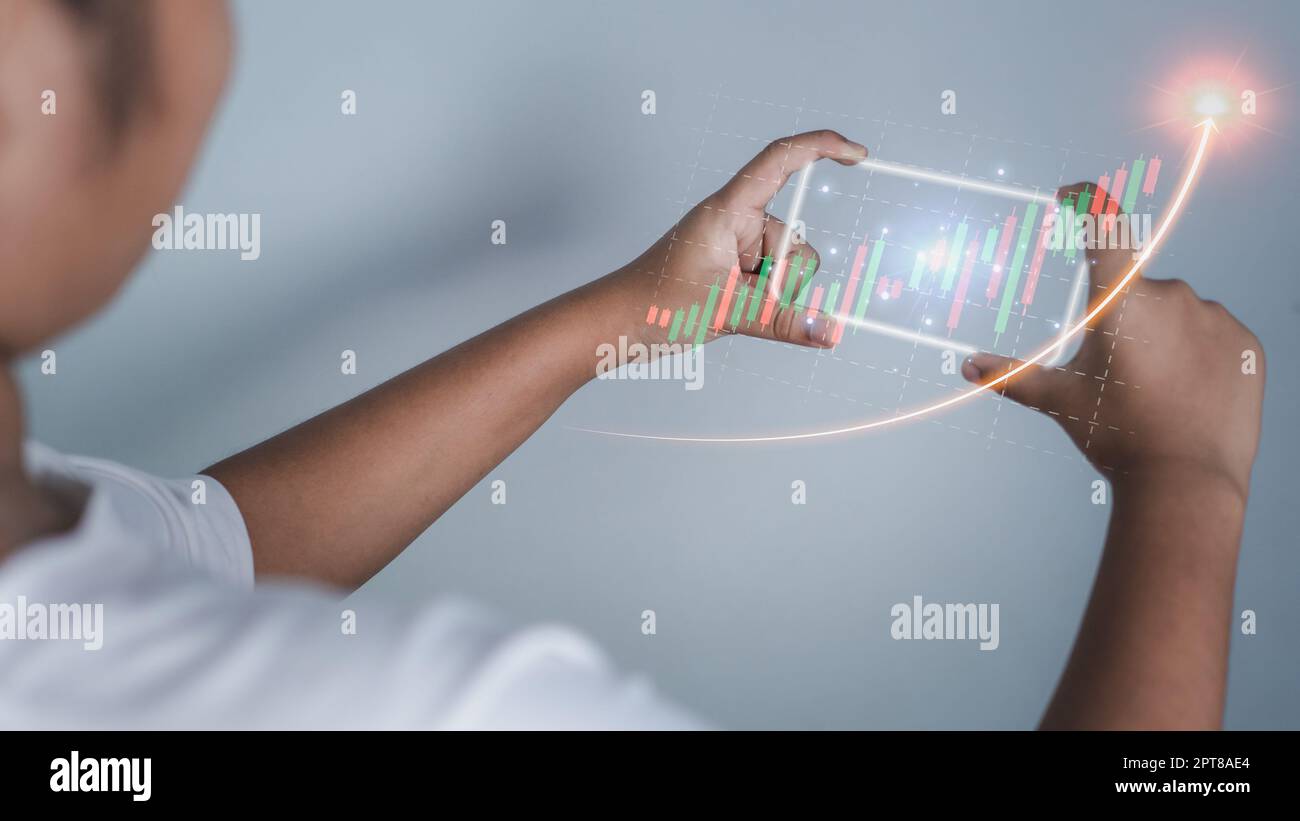 Hologram image of a candlestick chart from a phone on a person's hand ...