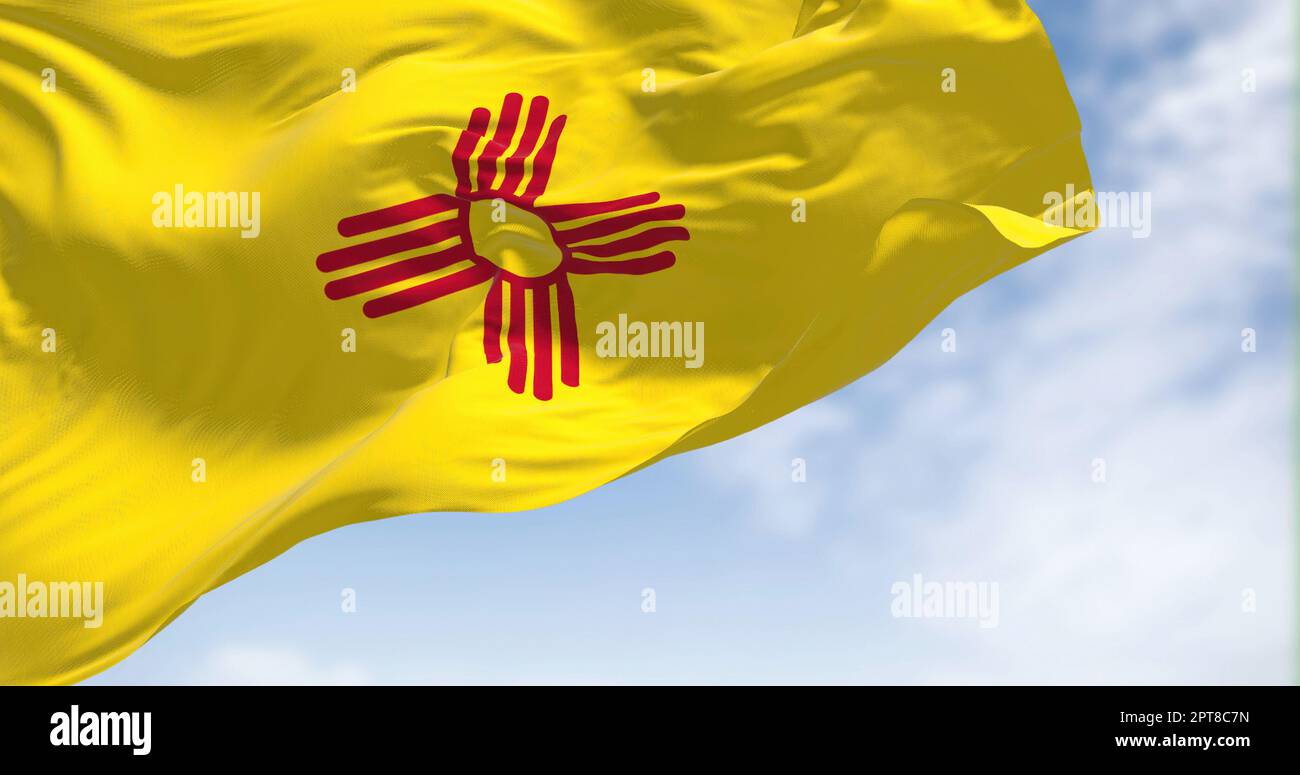 Flag of New Mexico state waving in the wind on a clear day. New Mexico ...