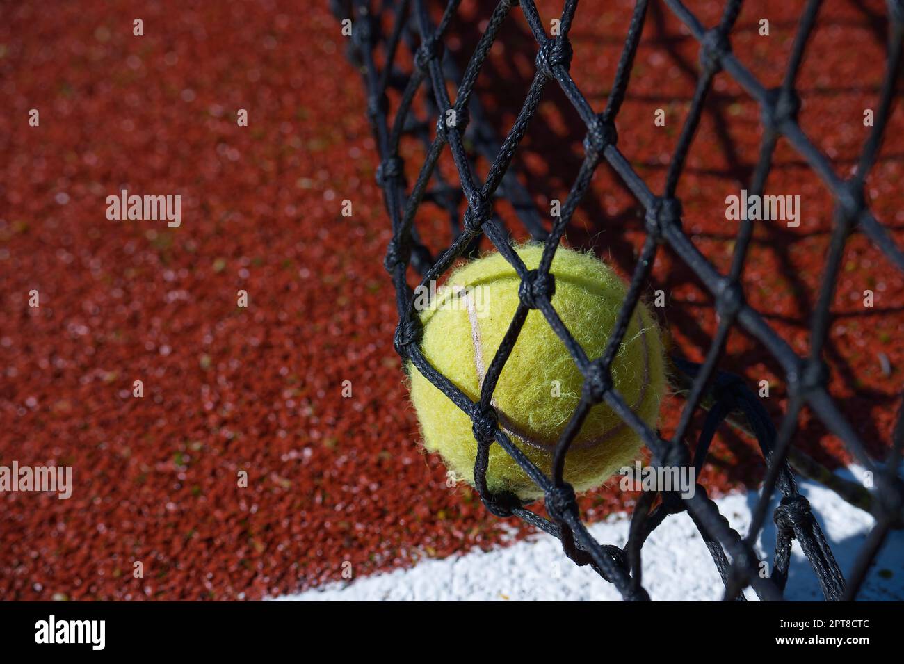 Tennis ball in the net. Ball hitting the tennis net, tennis scene with ...