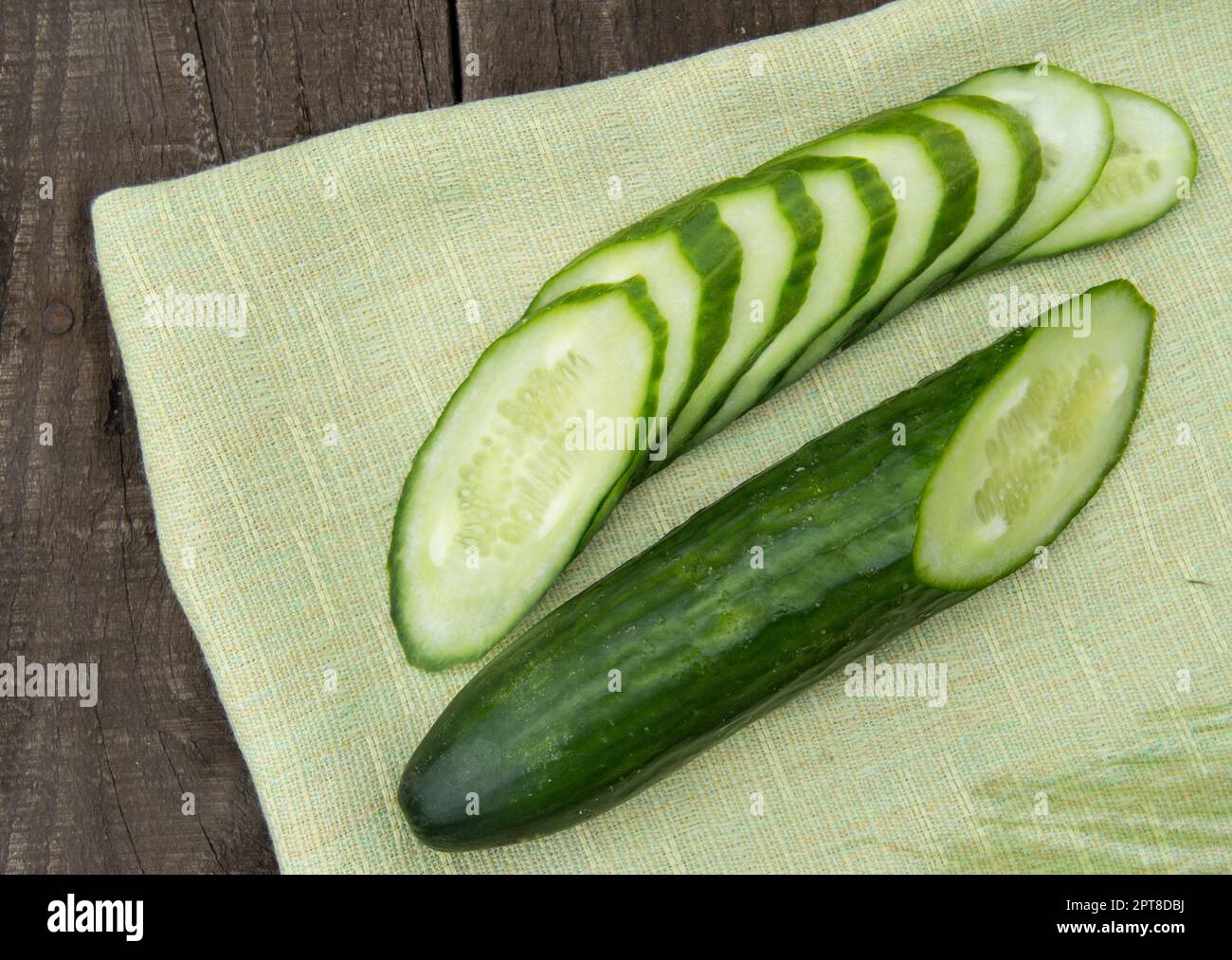 Fresh cucumber slices on the dark wood background and cloth Stock Photo ...