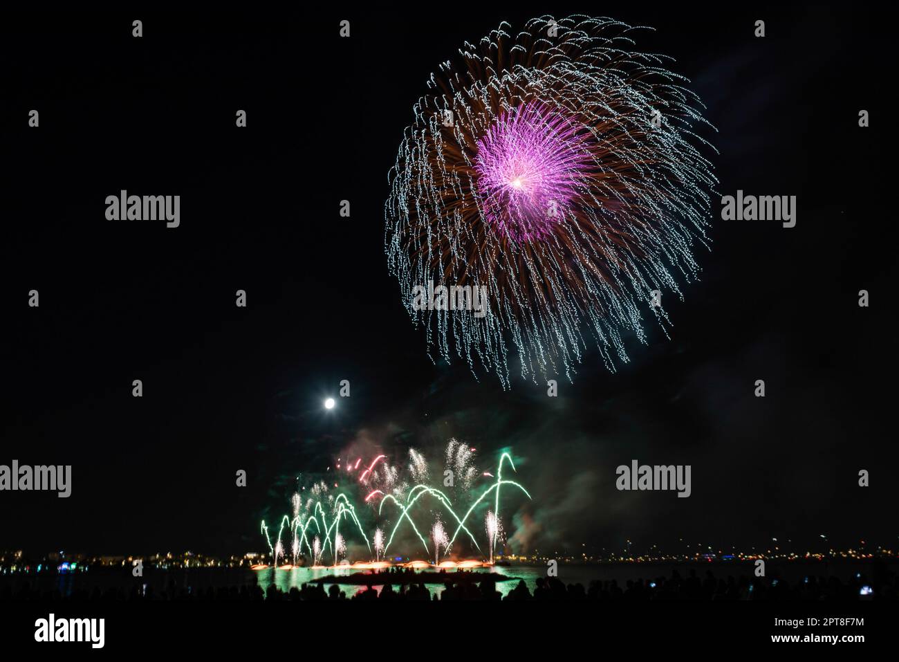 Scenic fireworks glowing in the night for the 14th of July celebrations ...
